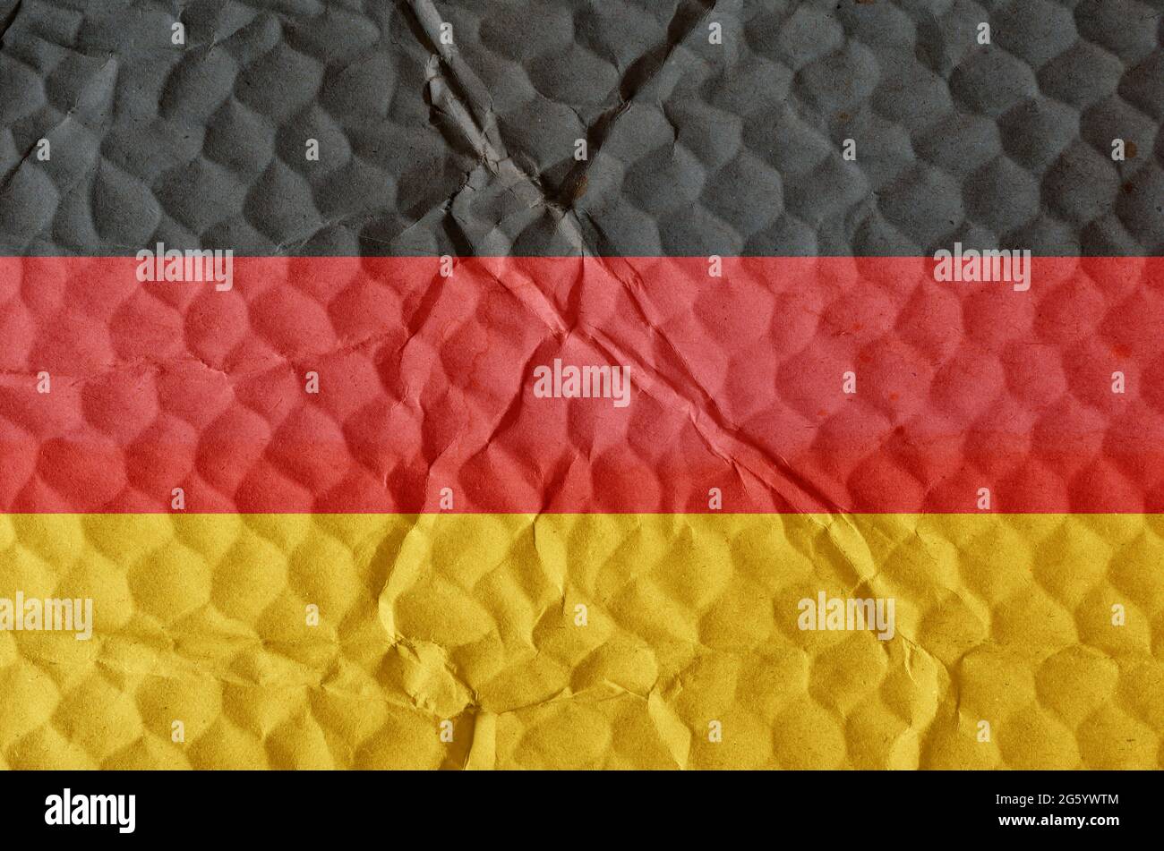 Brown-red-yellow flag of the Federal Republic of Germany on an uneven ...