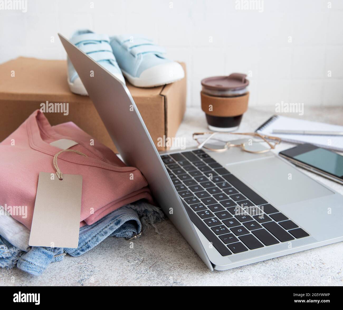 Online shopping concept. A laptop and a set of women's clothing in a ...
