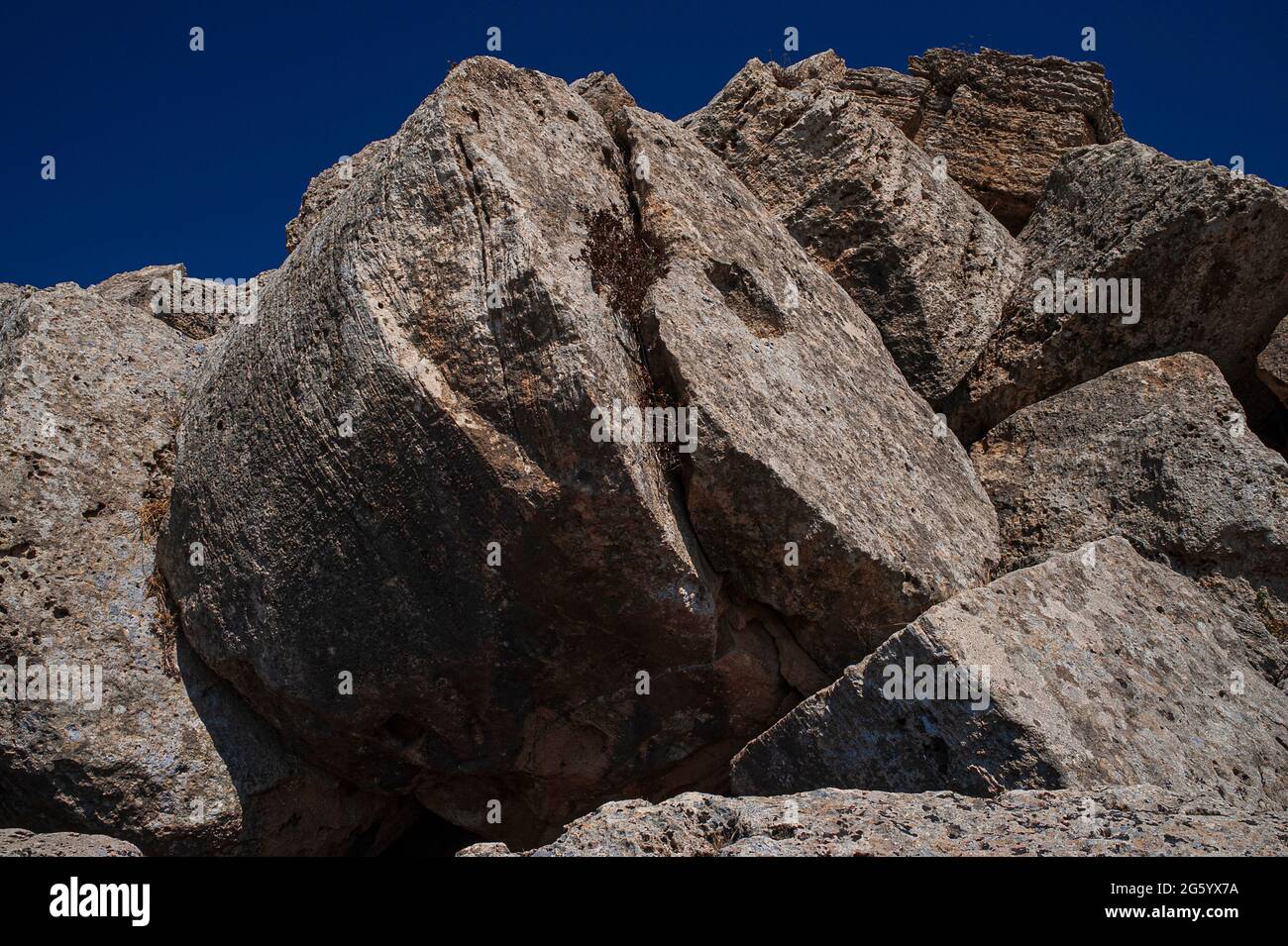 Massive drums of fallen columns and blocks of cut stone lie jumbled ...