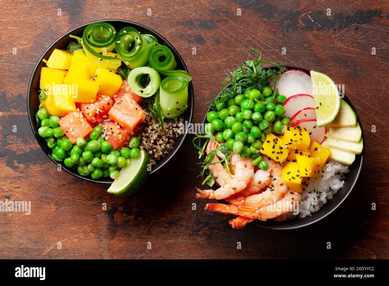 Poke bowls with shrimps, salmon, avocado and mango. Traditional ...