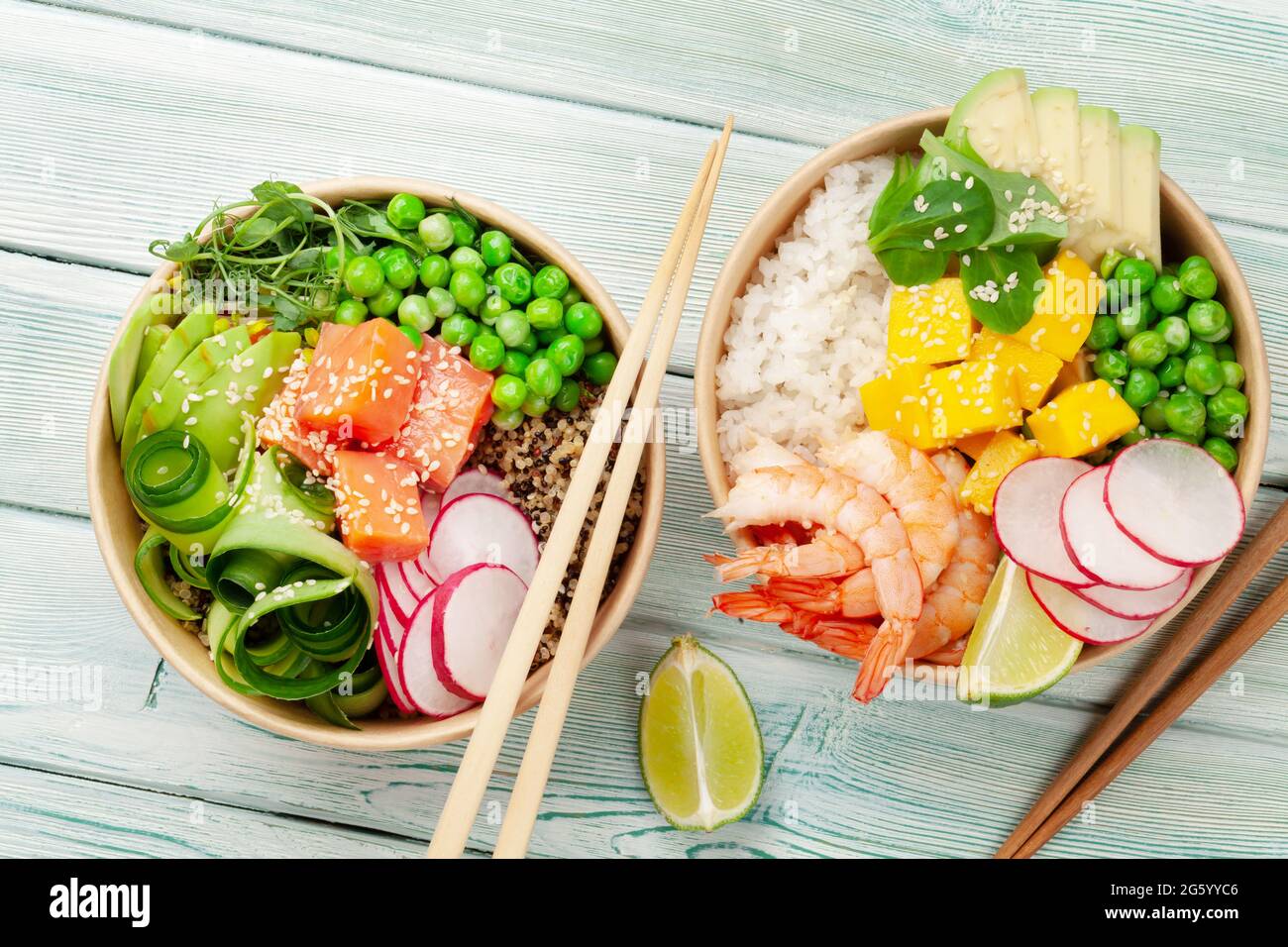 Poke bowls with shrimps, salmon, avocado and mango. Traditional ...
