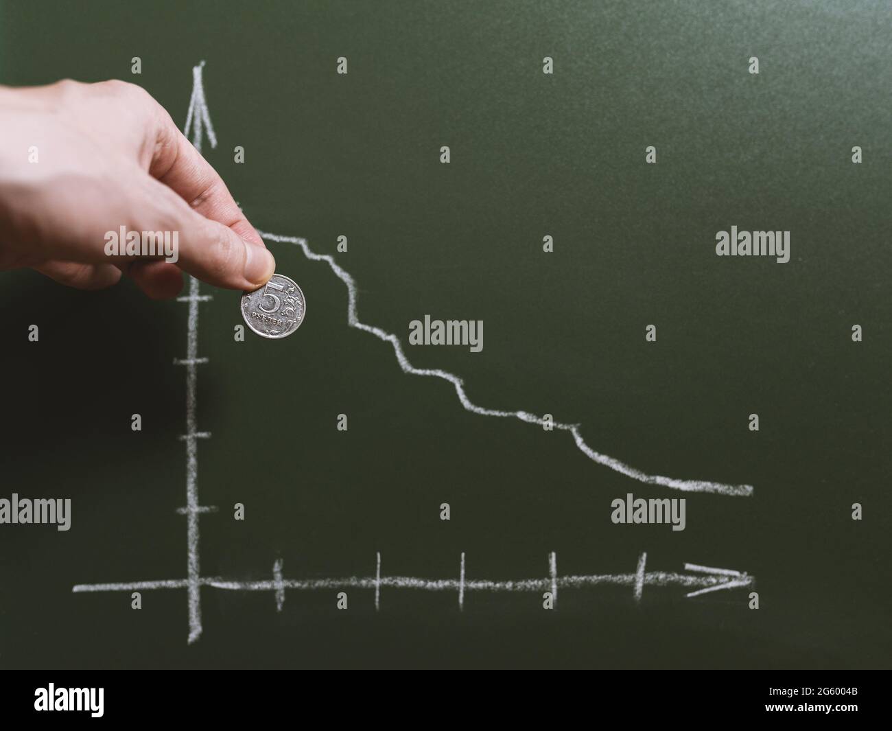 Chart with negative arrow and coin Stock Photo - Alamy