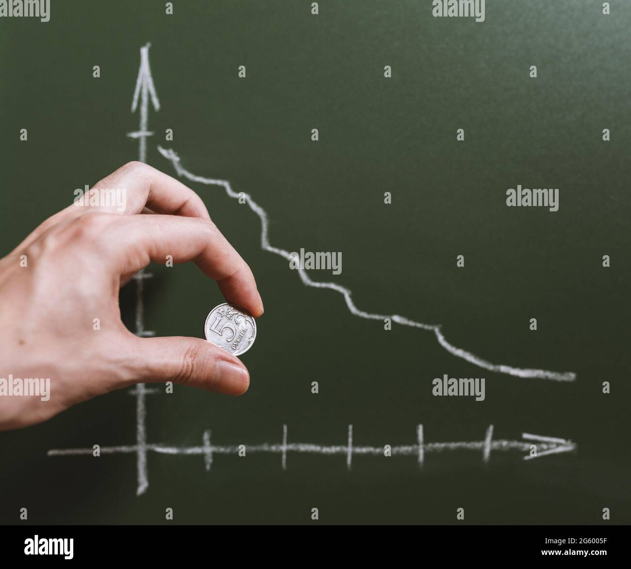 Chart with negative arrow and coin Stock Photo - Alamy