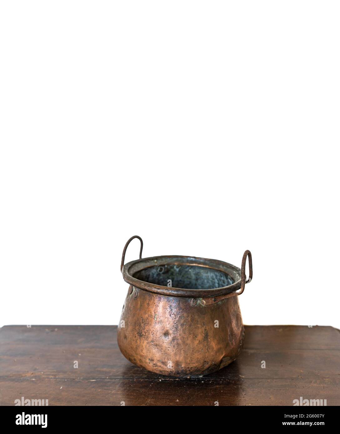 Antique copper pot over the table and white background Stock Photo - Alamy