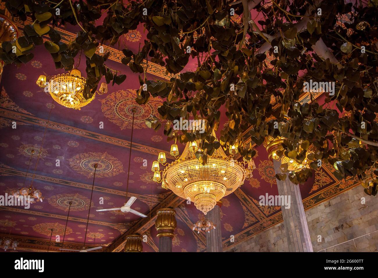 Ceiling with large chandeliers in the temple and golden leaves of the ...
