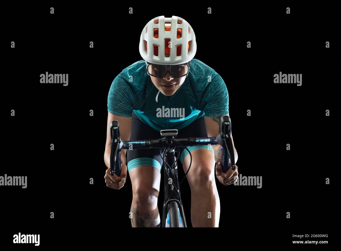 Professional young female cycler on road bike isolated over black ...