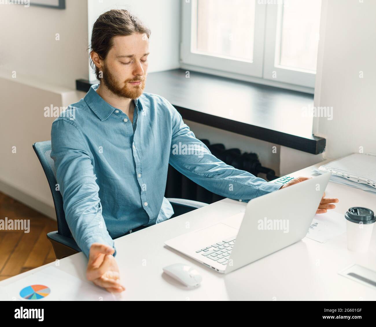 Calm male office worker meditating with closed eyes at work Stock Photo ...