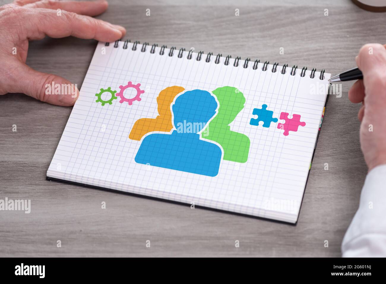 Hand holding a notepad with teamwork concept Stock Photo - Alamy