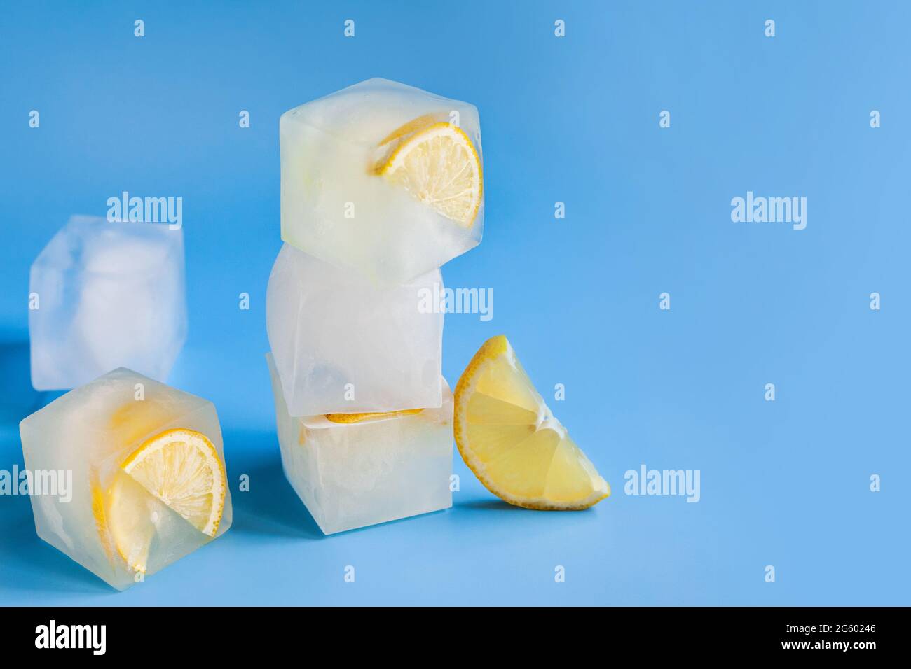 Modern composition of the frozen slices of lemon and ice cubes on a blue background Stock Photo ...