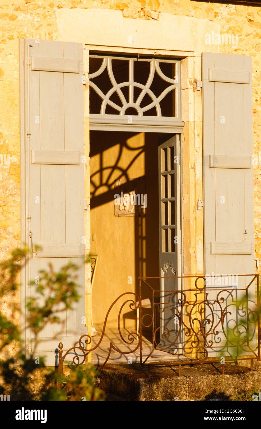 Open front door with shutters Stock Photo - Alamy