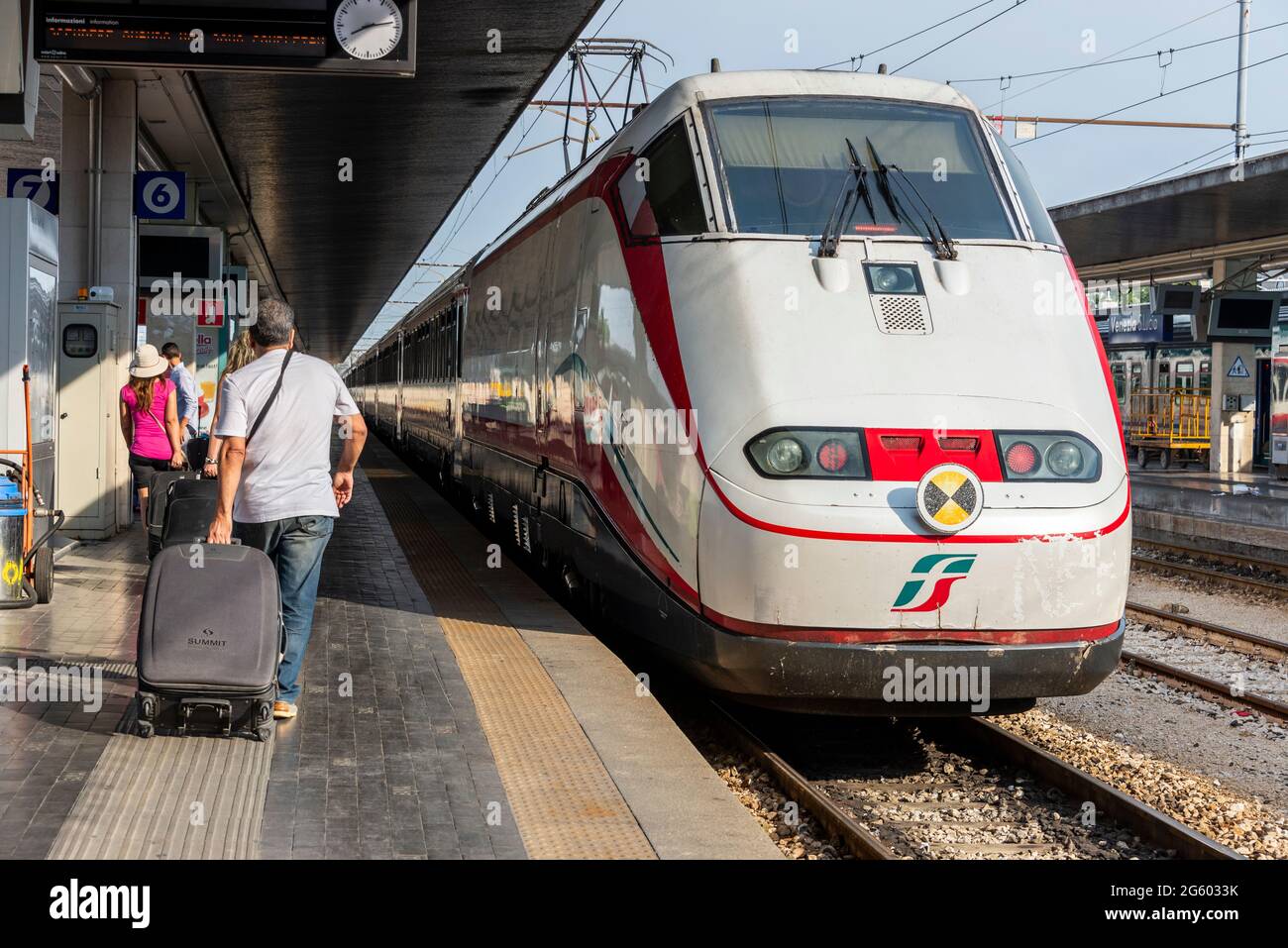 Passengers boarding an express train at Santa Lucia railway station in ...