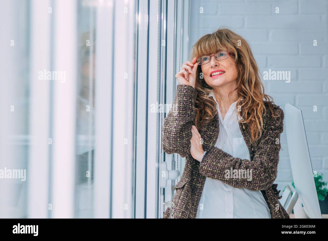 business woman at office window Stock Photo - Alamy