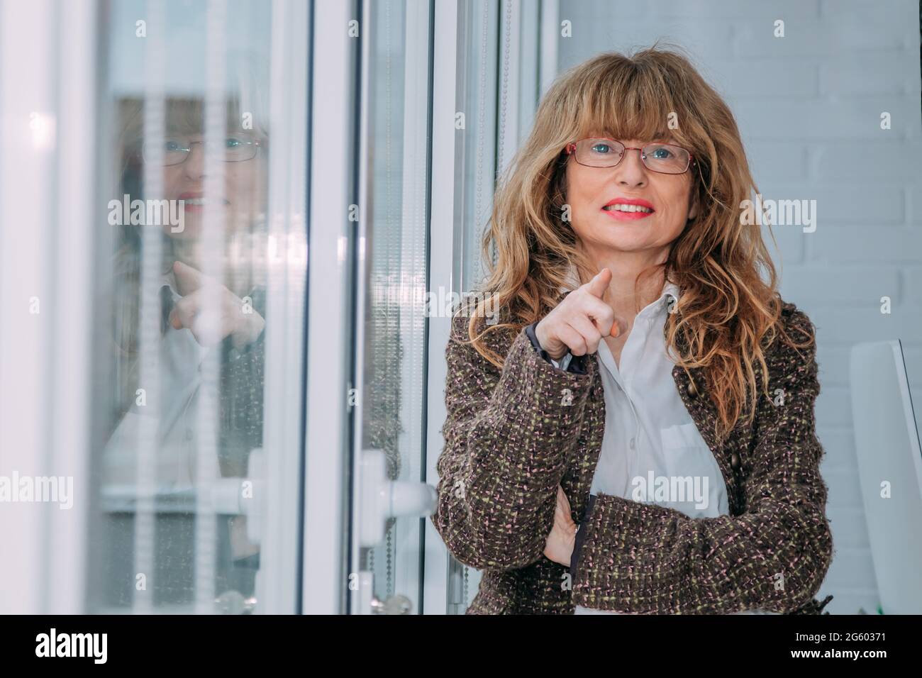 business woman at office window Stock Photo - Alamy