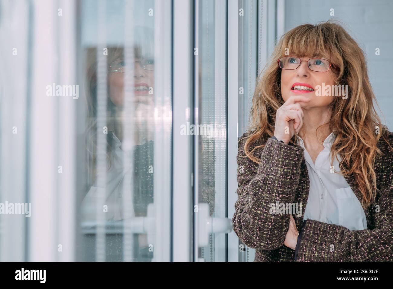 business woman at office window Stock Photo - Alamy
