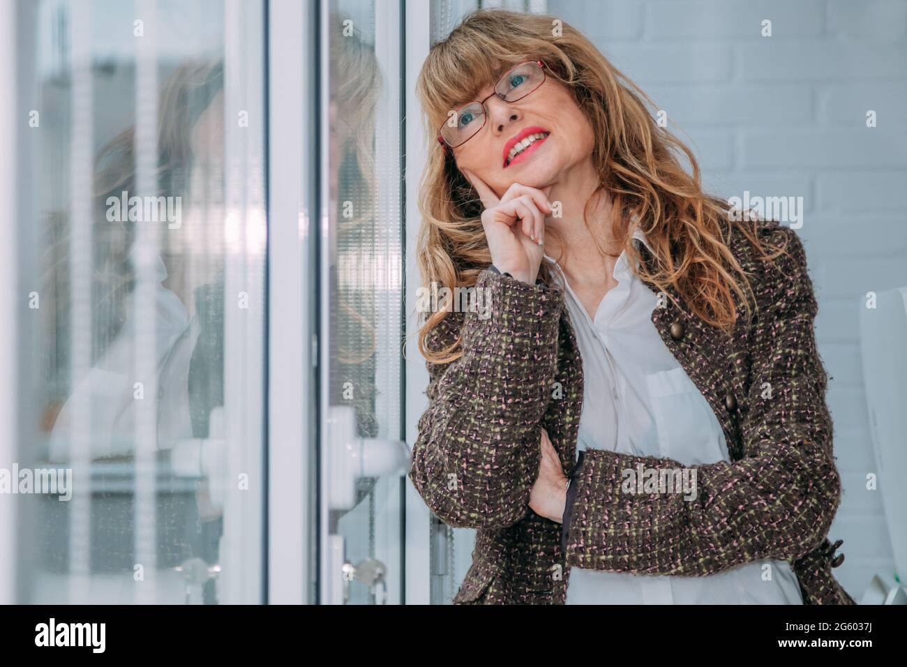 business woman at office window Stock Photo - Alamy