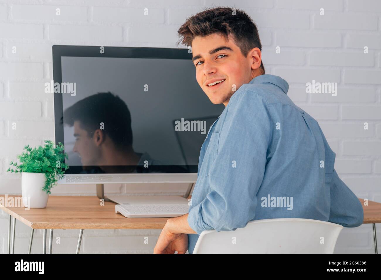 teenage student with computer on desk Stock Photo - Alamy