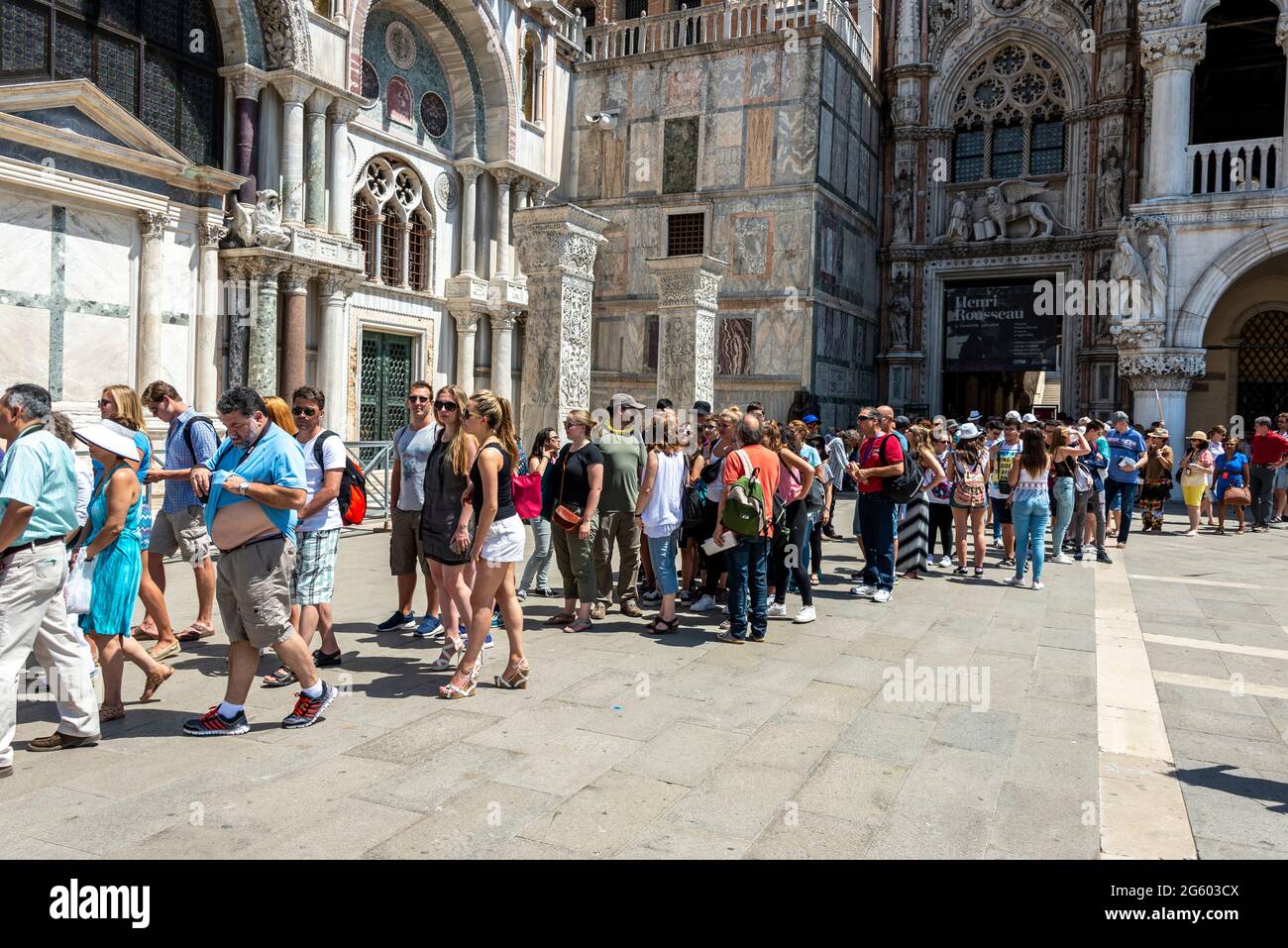A long queue of tourists waiting patiently outside the Basilica di San ...