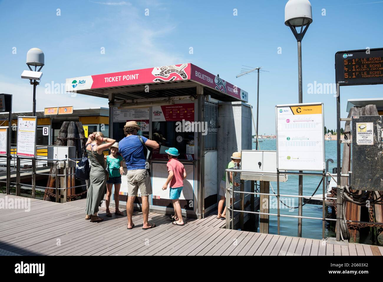 A family purchase tickets at one of the ACTV Vaporetto stops (Venetian ...