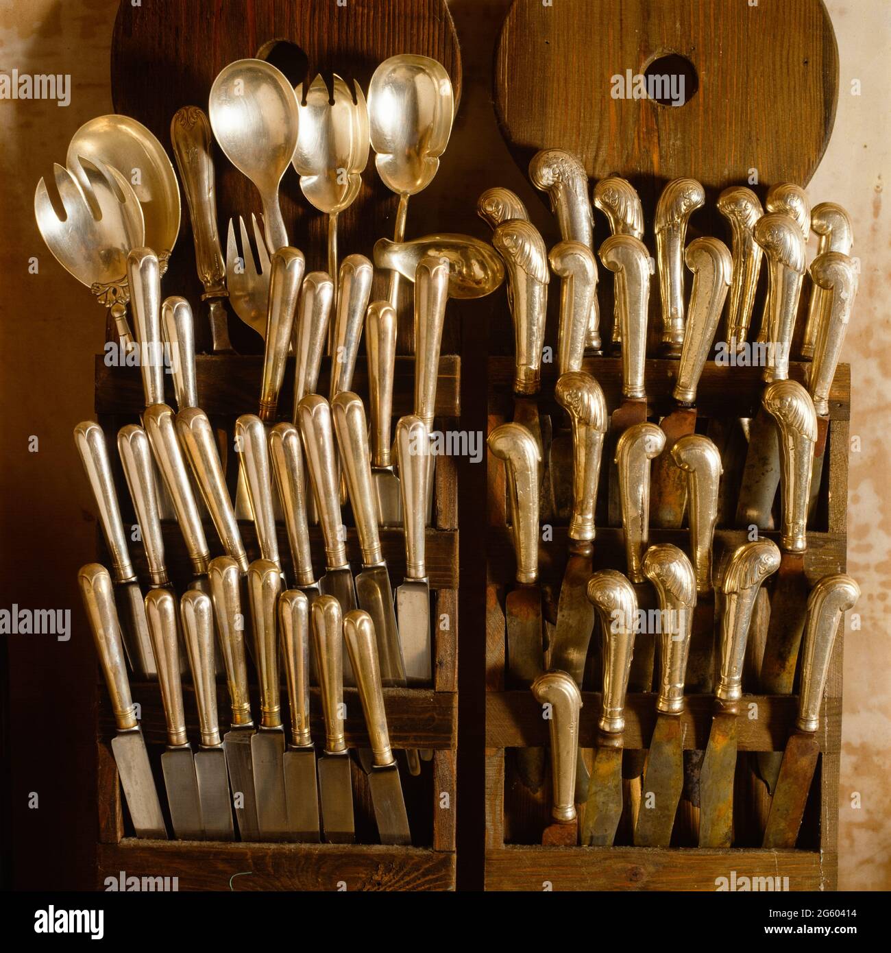 Silver cutlery in wooden racks Stock Photo - Alamy