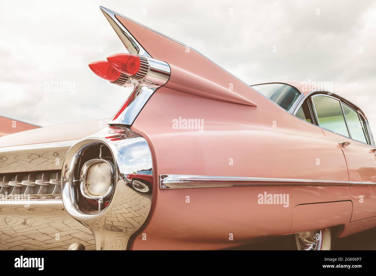 Retro styled image of the rear end of a pink classic car Stock Photo ...