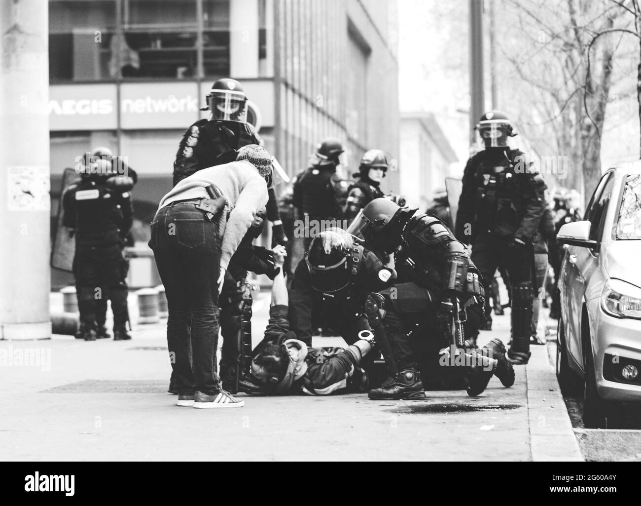Police officers are beating down a protestor in Lyon, France, during a ...