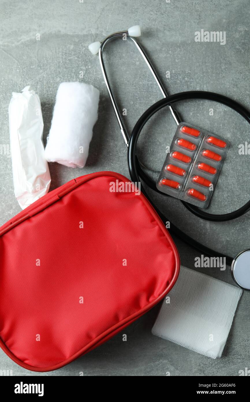 First aid medical kit on gray textured table Stock Photo - Alamy