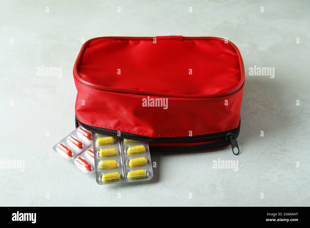 First aid medical kit on white textured table Stock Photo - Alamy