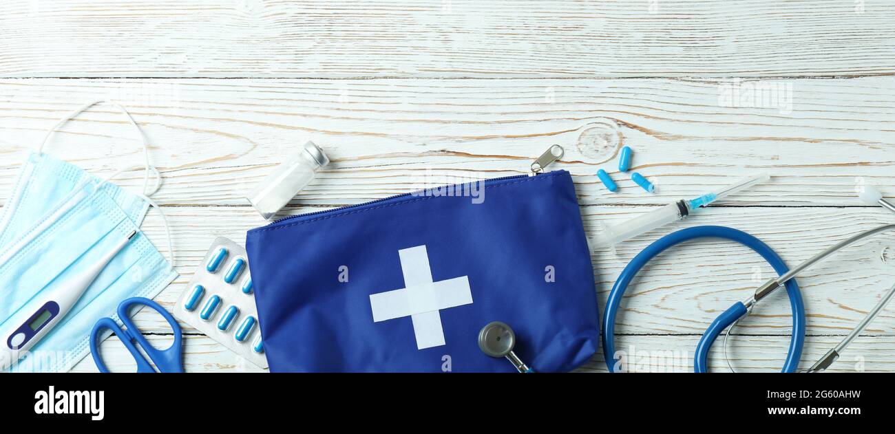 First aid medical kit on white wooden table Stock Photo - Alamy