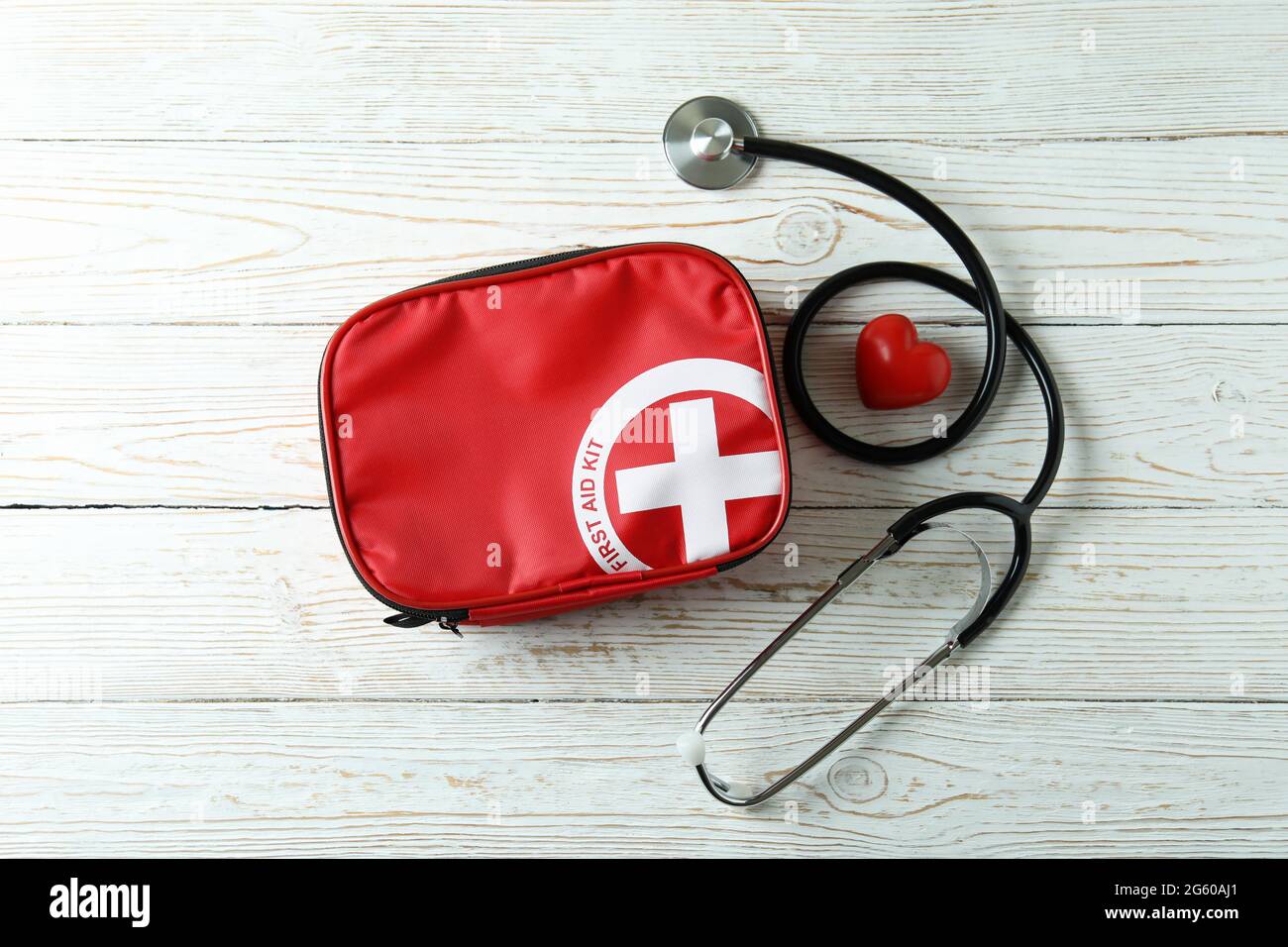 First aid medical kit on white wooden table Stock Photo - Alamy