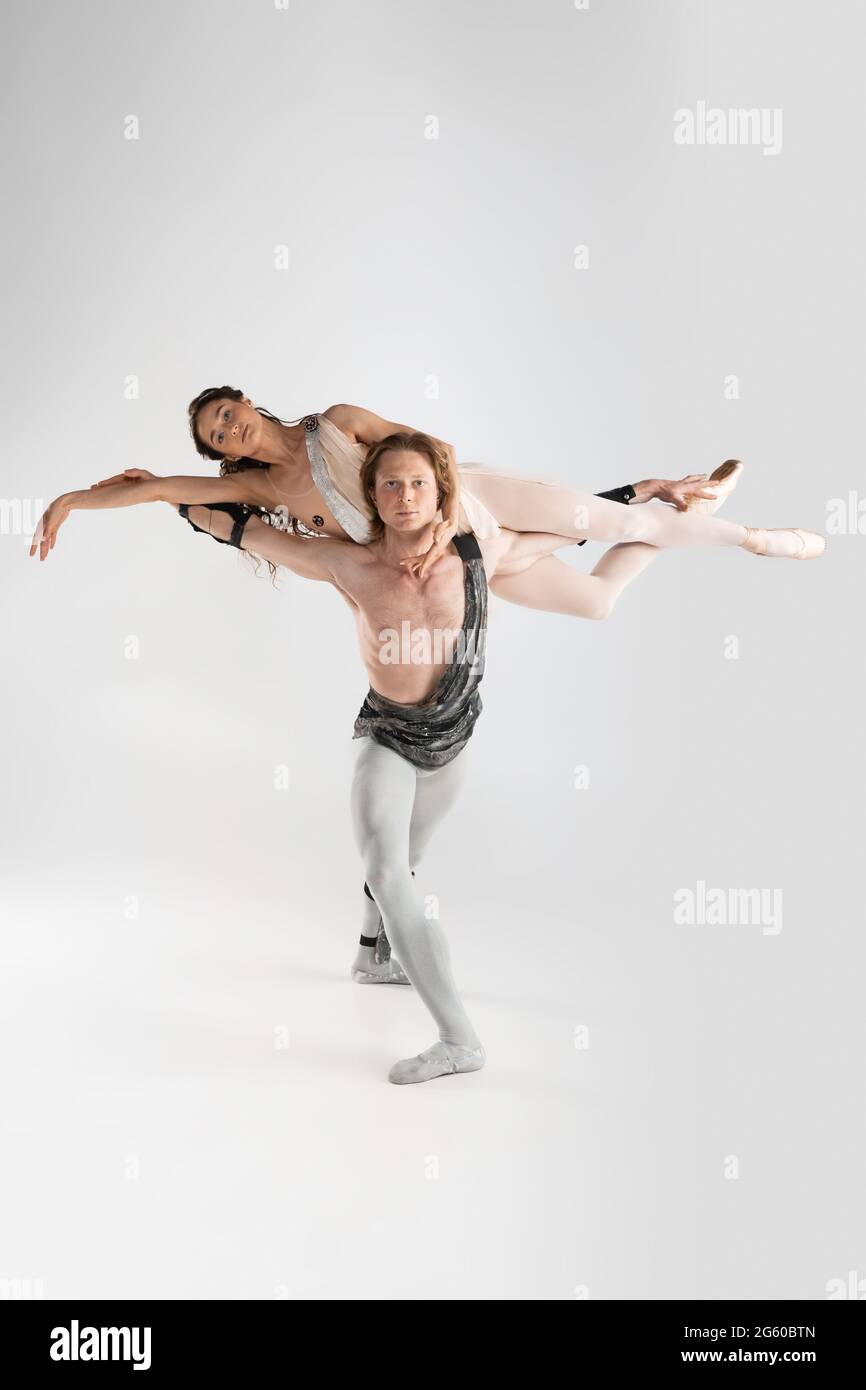Young couple of ballet dancers in ancient Rome costumes dancing on ...