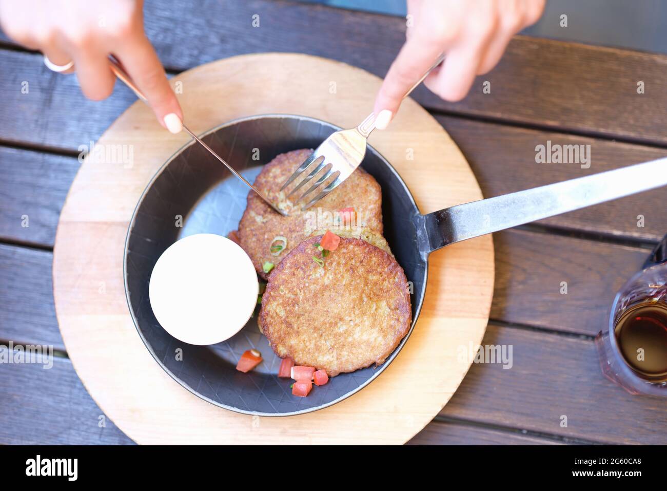 Woman eating potato pancakes hi-res stock photography and images - Alamy