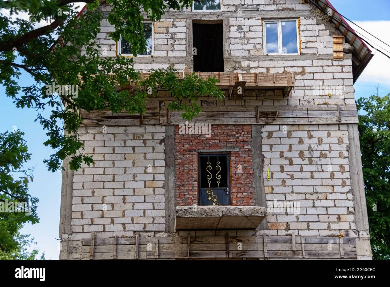 Construction of a small brick house in nature, unfinished building ...