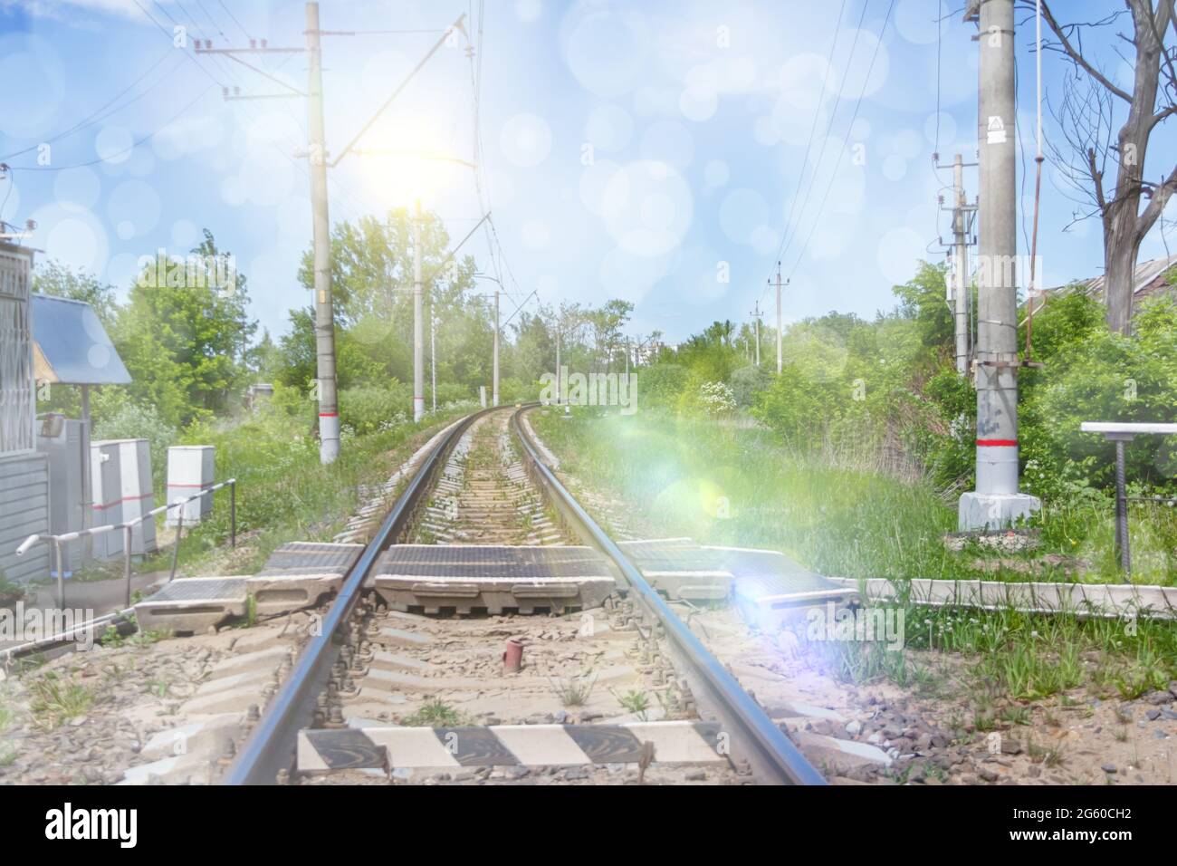The railway going away into the distance. Railroad crossing with green ...