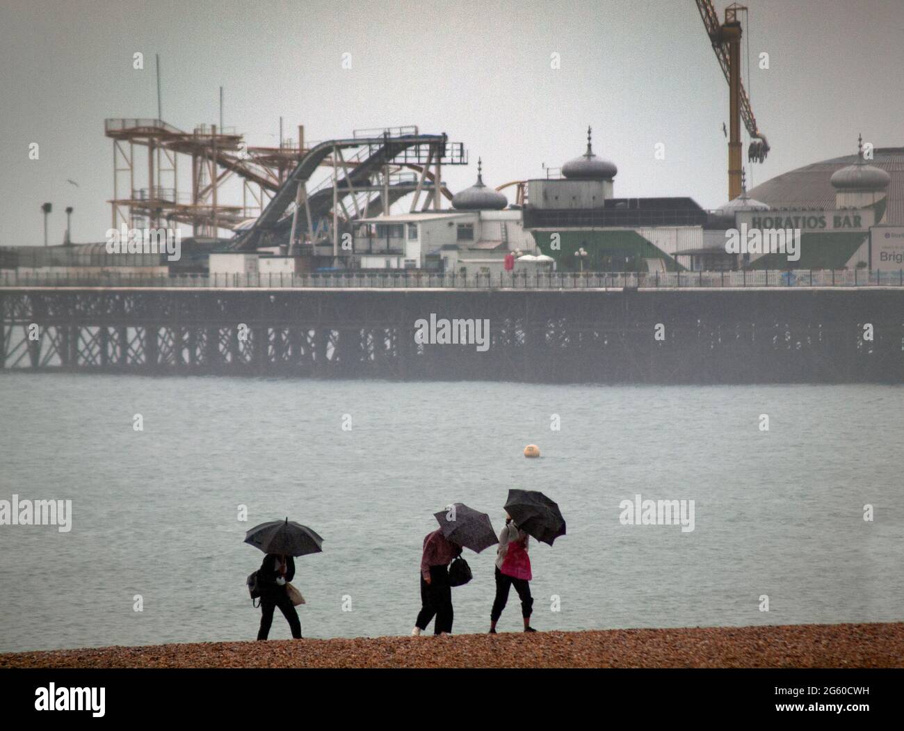 A wet day on the beach at Brighton Stock Photo - Alamy