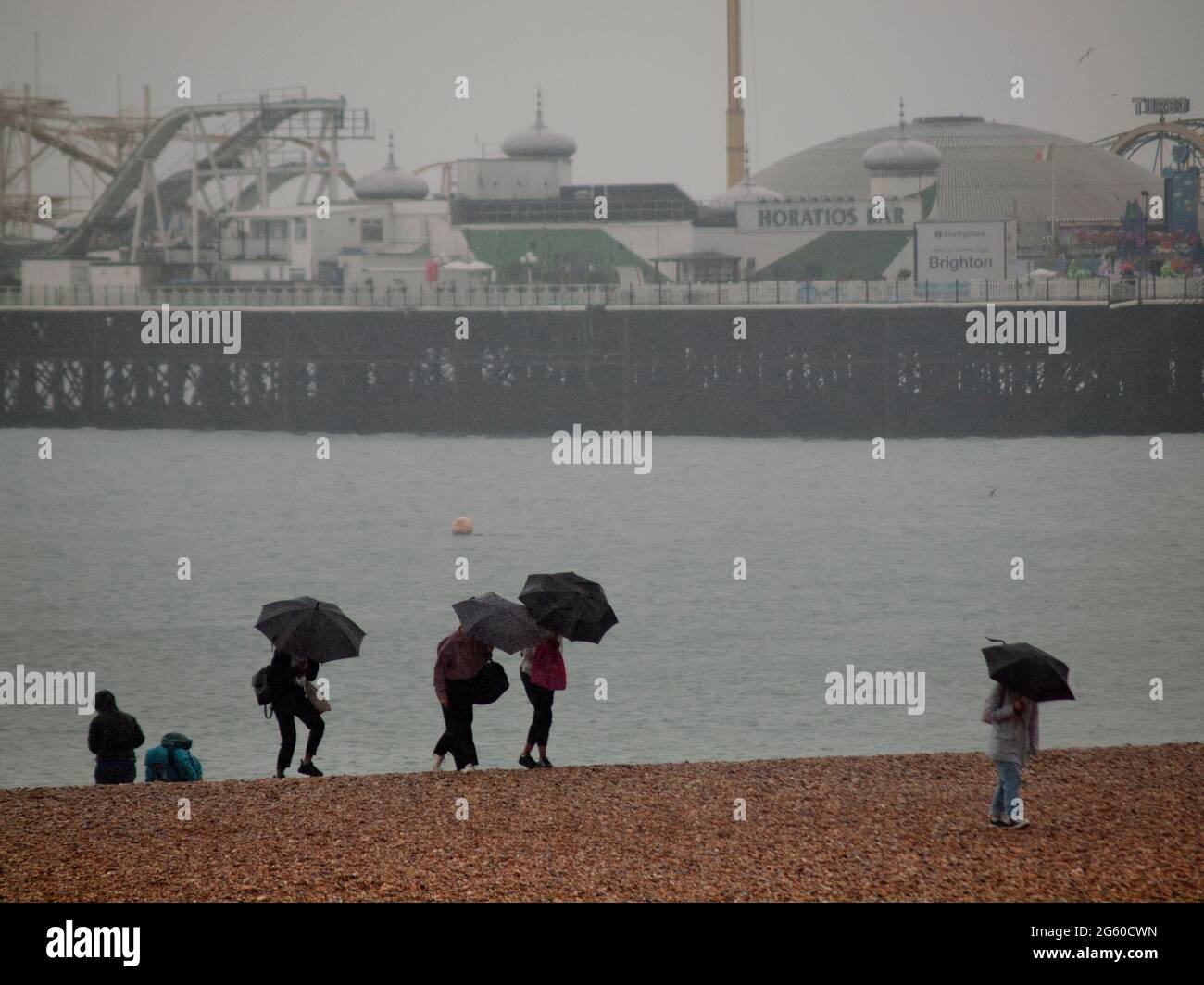 A wet day on the beach at Brighton Stock Photo - Alamy