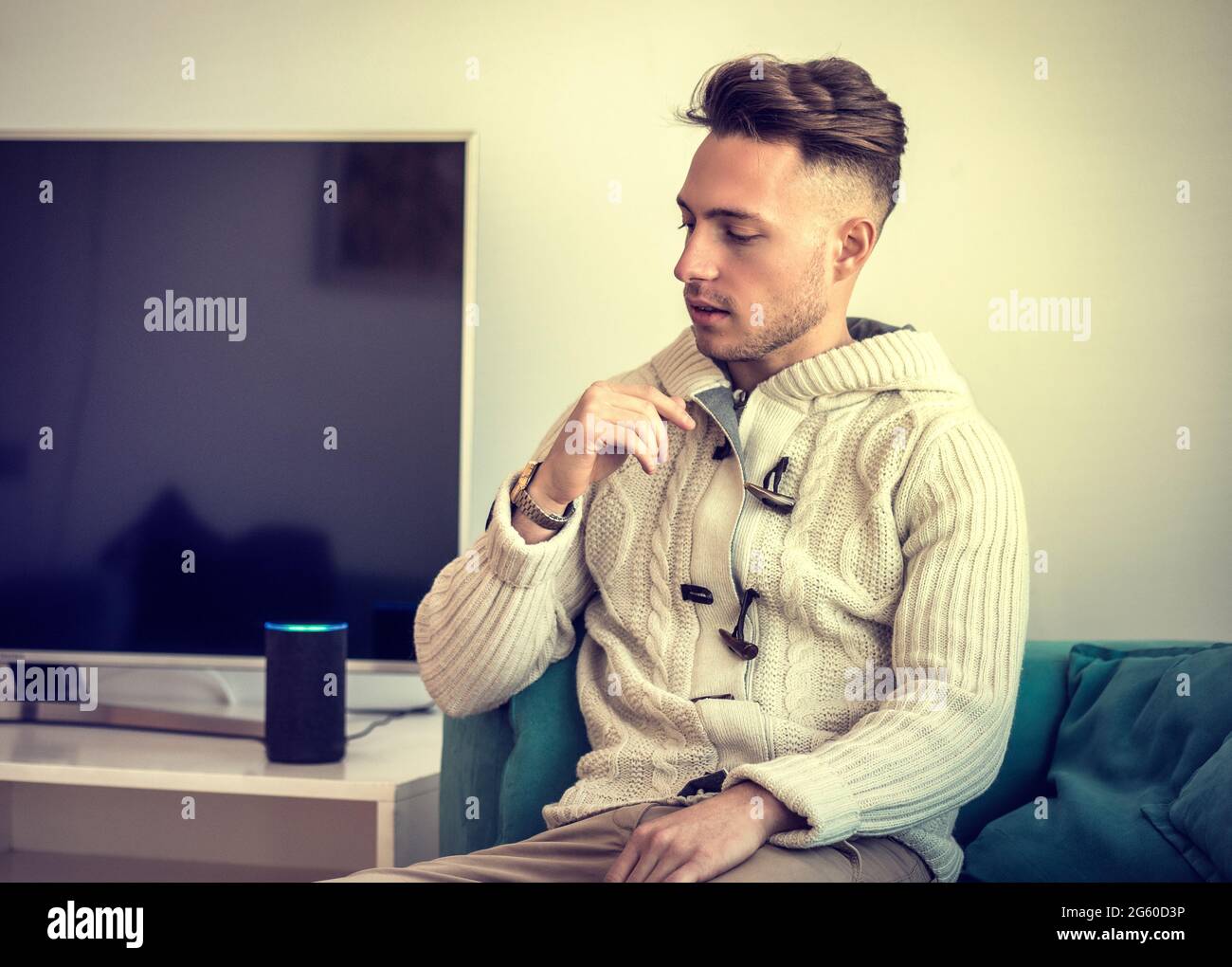 Young man speaking to smart electronic speaker home assistant Stock ...