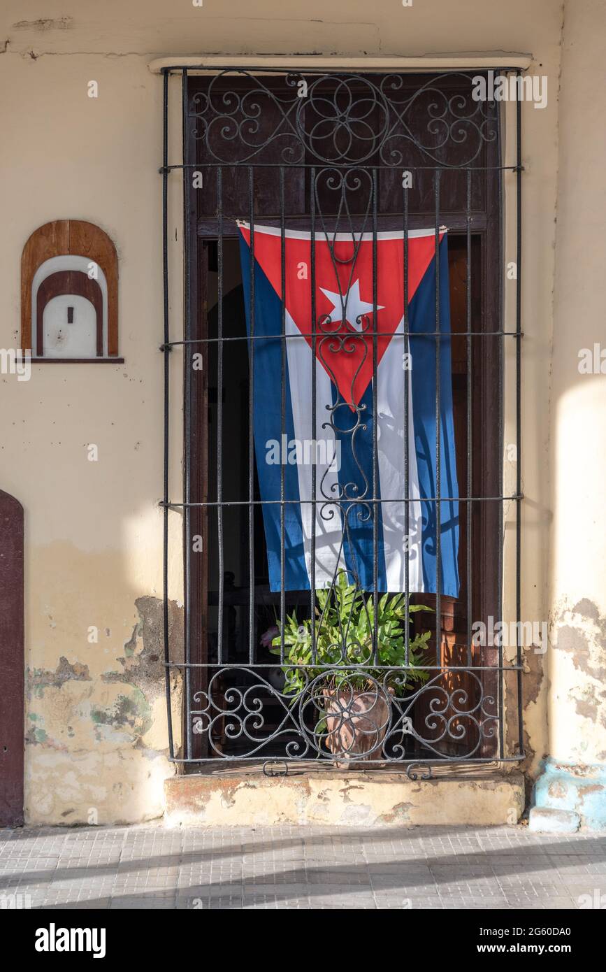 Cuban flag in colonial style window, facade of building, Cuba, 2016 ...