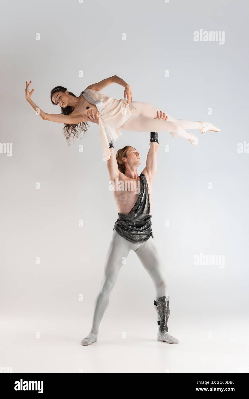 Young couple of ballet dancers in ancient Rome costumes dancing on ...