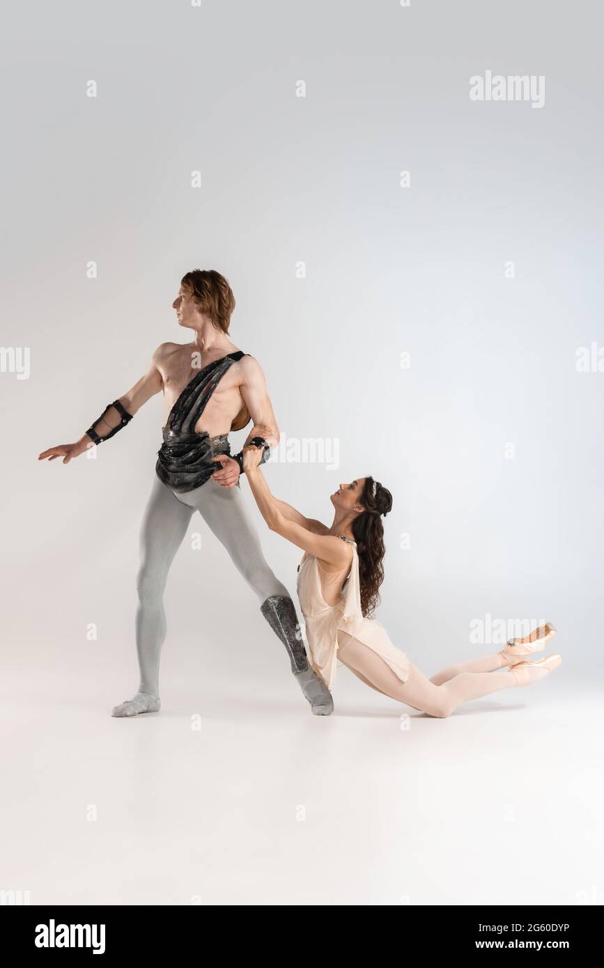 Young couple of ballet dancers in ancient Rome costumes dancing on ...