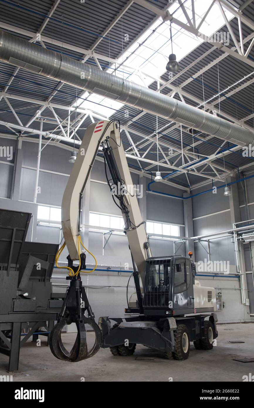 Loader and grab crane for handling waste. Waste sorting and recycling ...