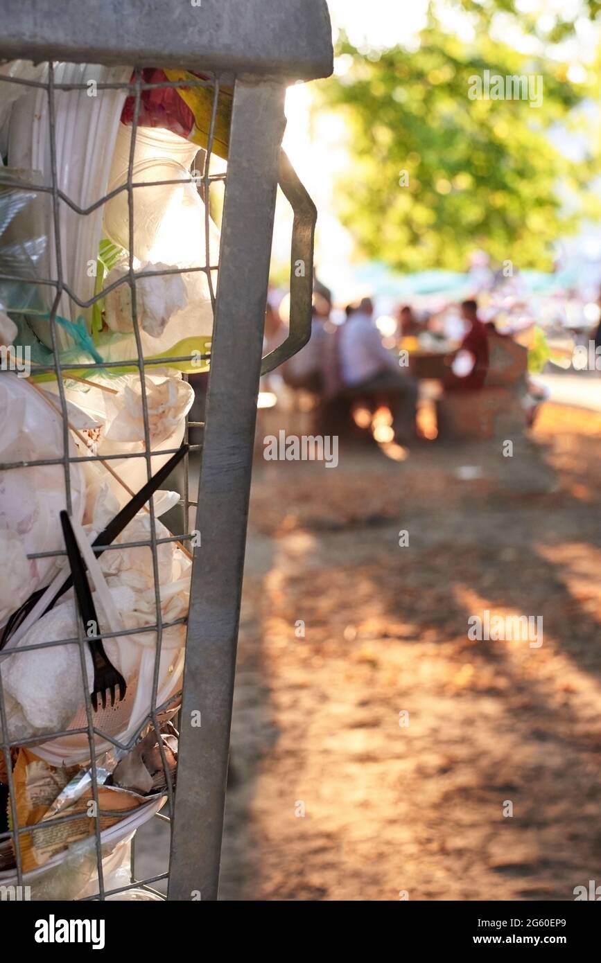 Waste container filled with plastic bottles, dishes and other rubbish ...
