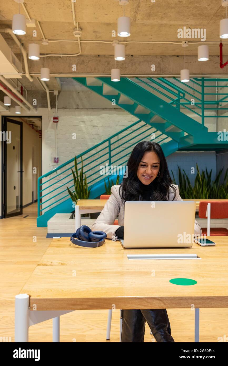 Brunette business woman working from her workspace Stock Photo - Alamy