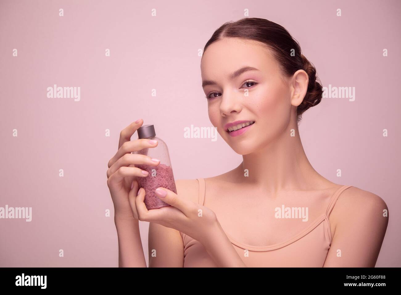 Portrait of beautiful young woman isolated on light pink studio ...