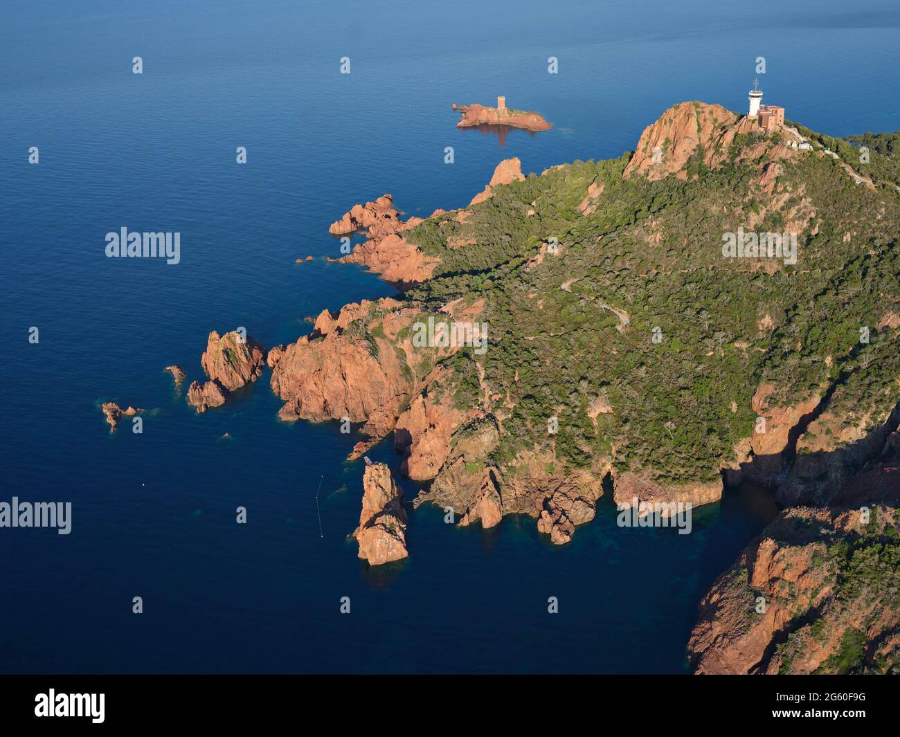 AERIAL VIEW. Jagged promontory of red rhyolite and sparse Mediterranean ...
