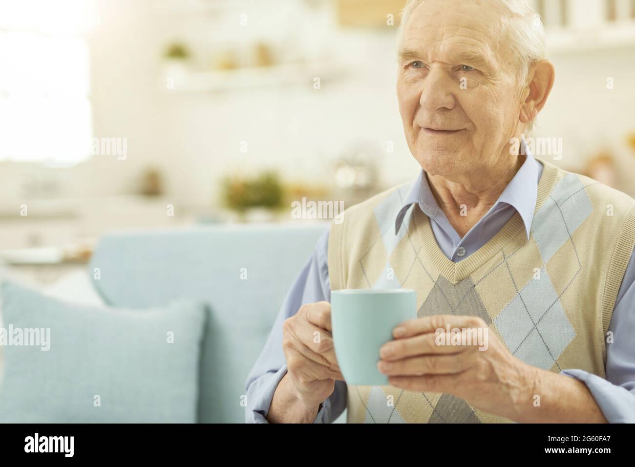 Pensioner relaxing at home with a cup of hot tea Stock Photo - Alamy