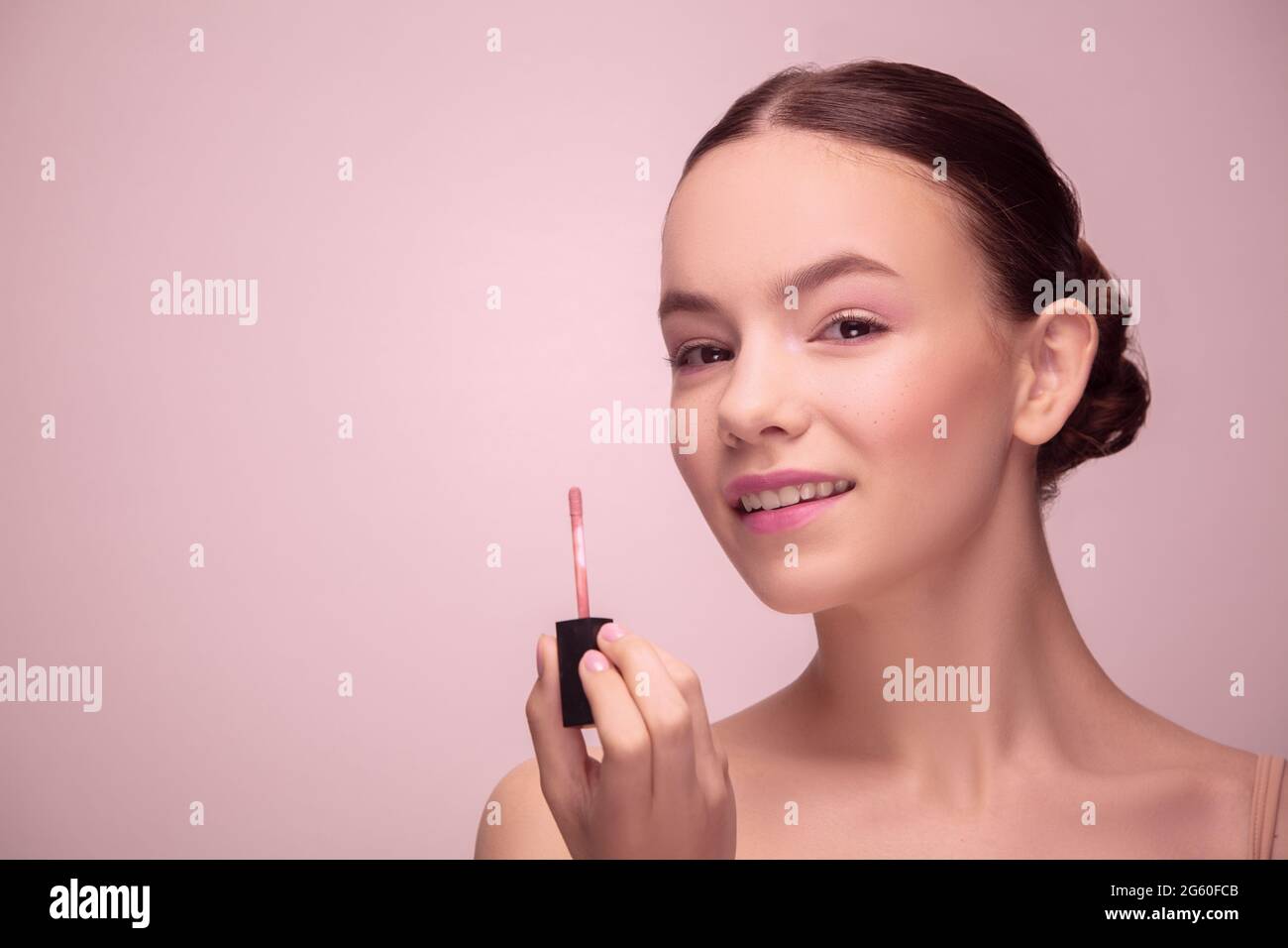 Portrait of beautiful young woman isolated on light pink studio ...