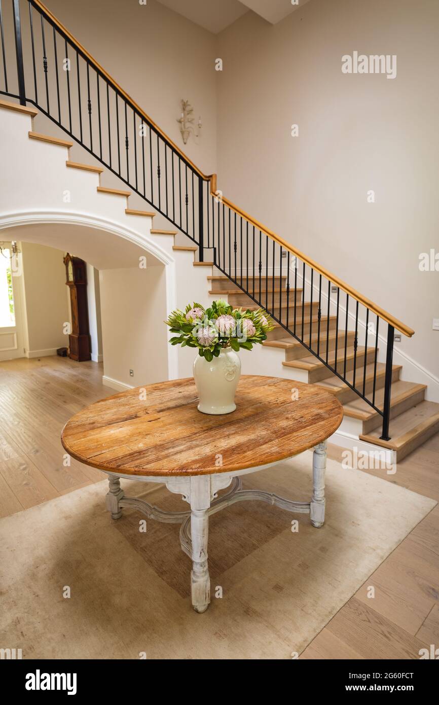 General view of house interior with table and vase with flowers in ...