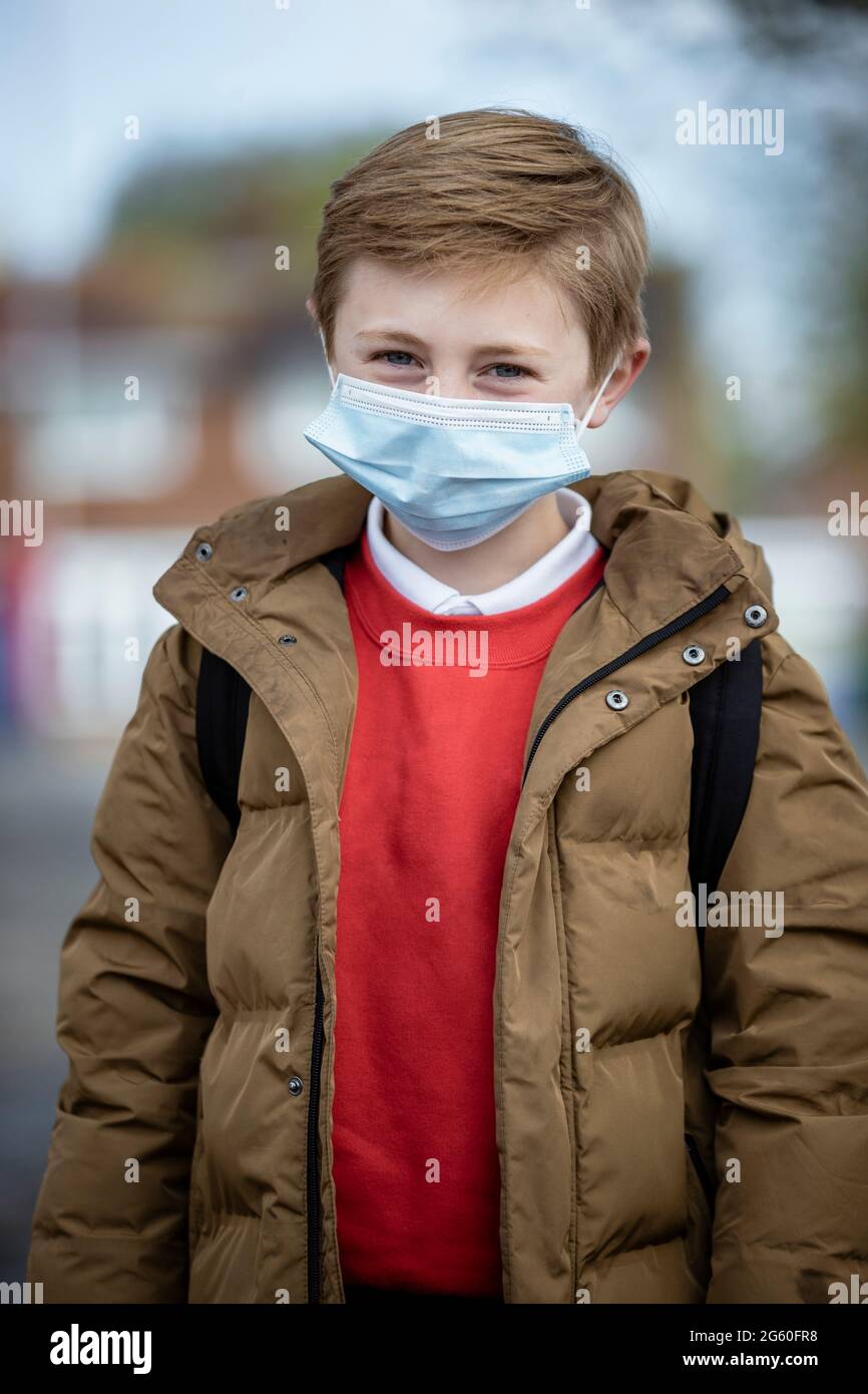A front-view portrait shot of a young caucasian boy wearing a school ...