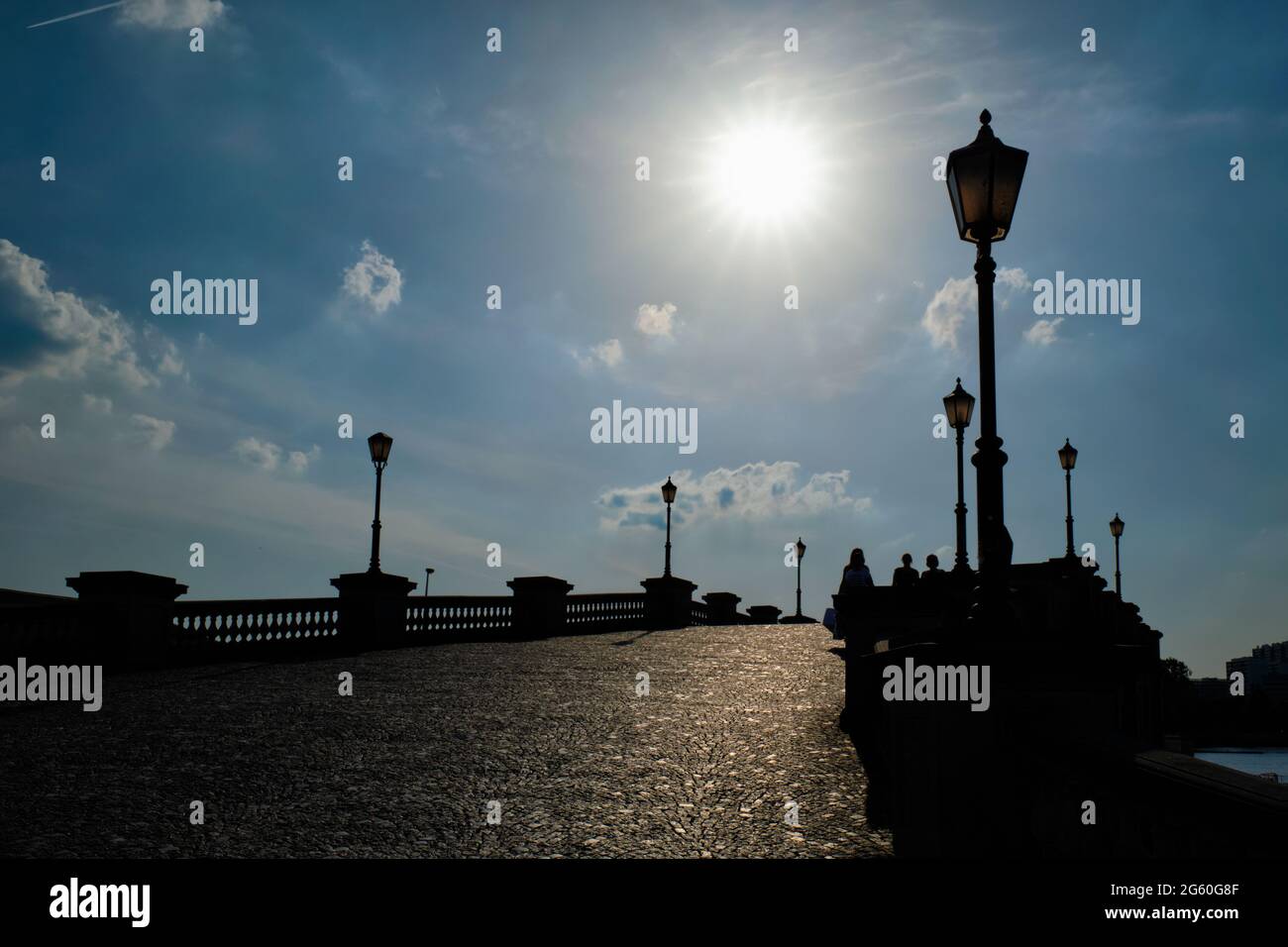 Silhouettes of people and street lamps Stock Photo - Alamy