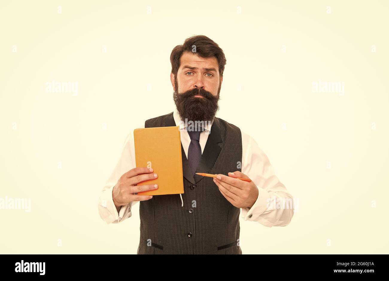 Serious bearded man point writing pen at school book isolated on white ...